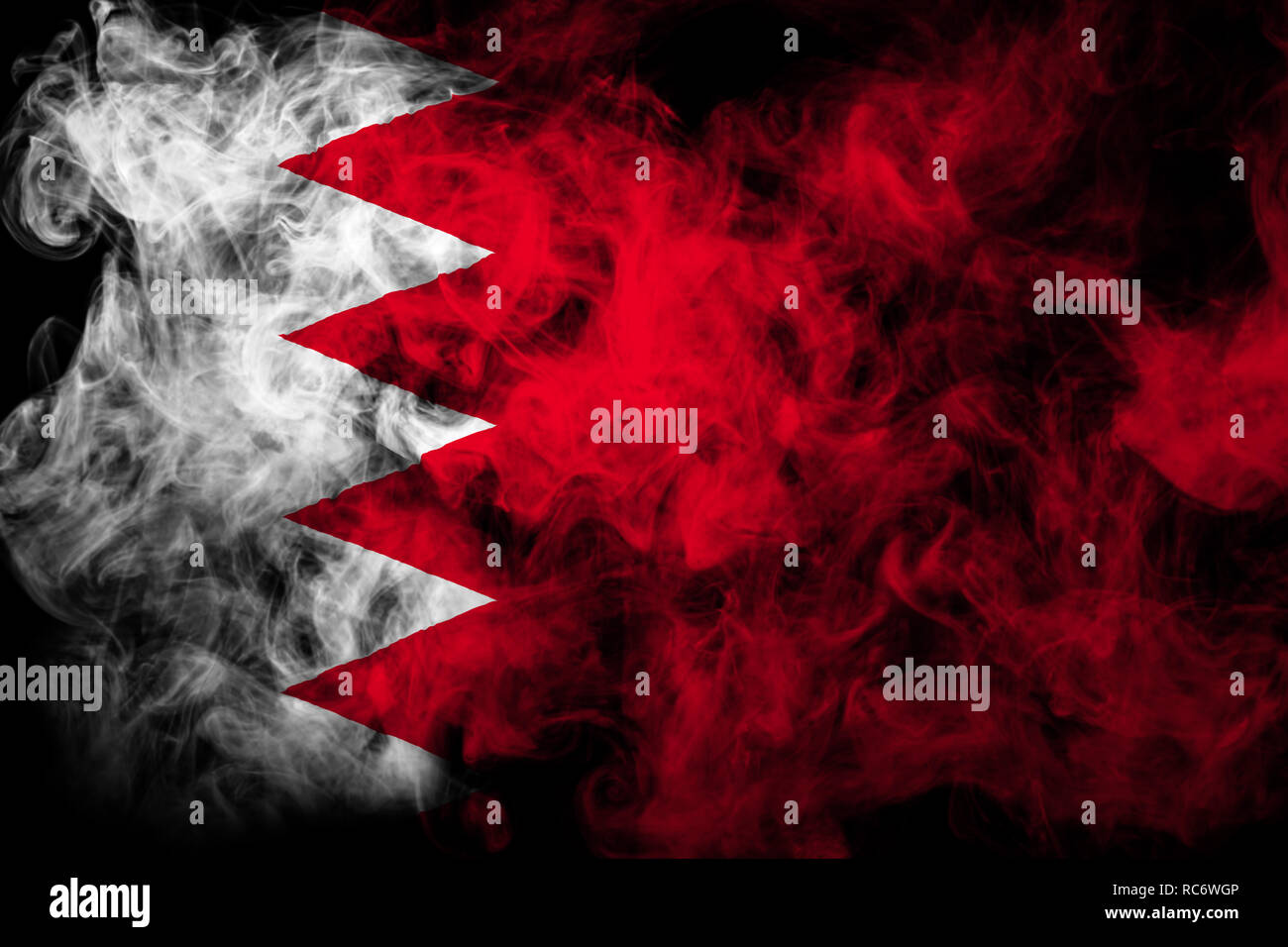 National flag of Bahrain from thick colored smoke on a black isolated ...