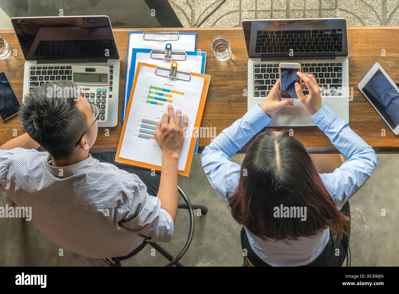 Overhead business angle of Asian employees working Stock Photo - Alamy