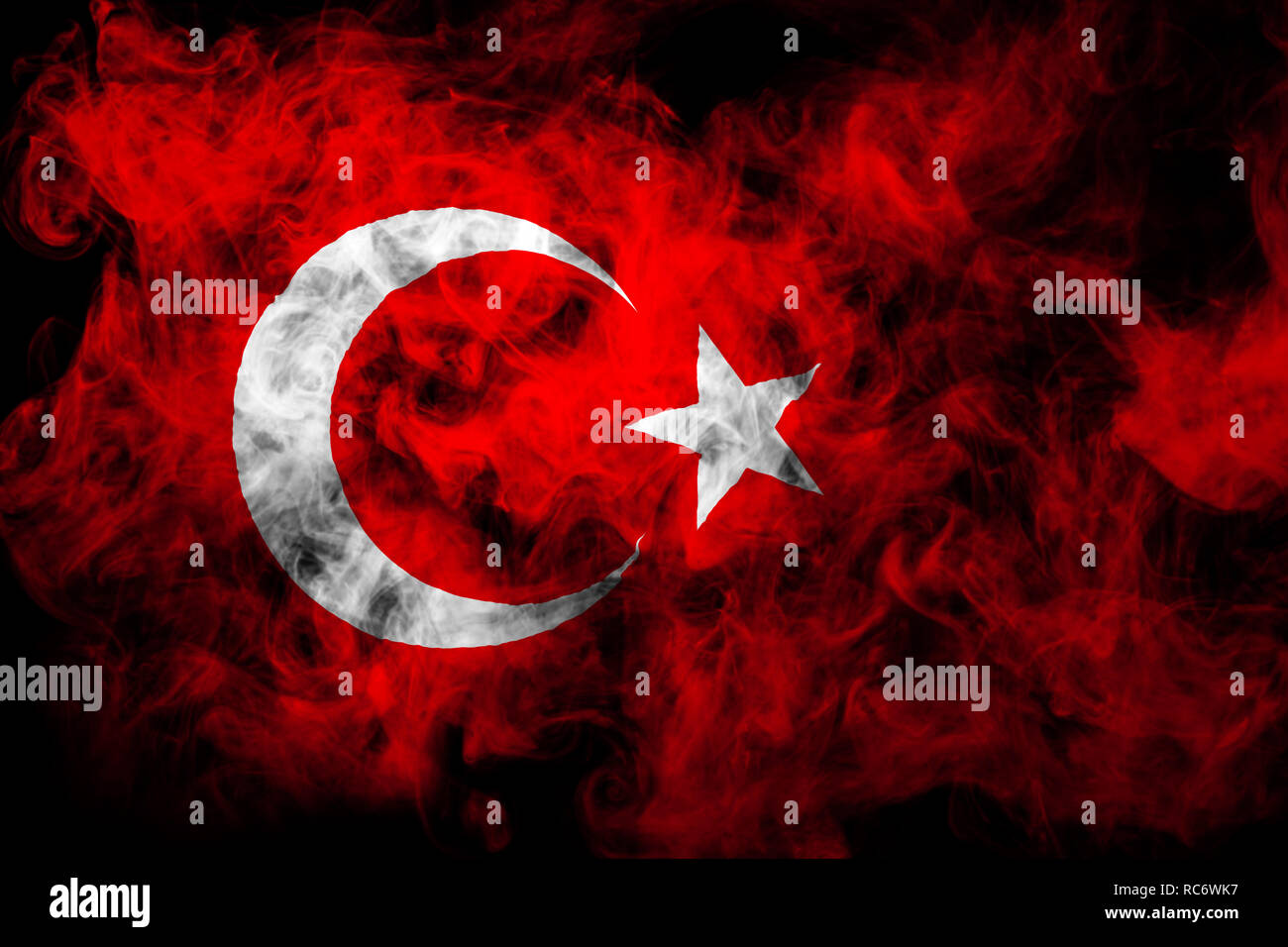 National flag of Turkey from thick colored smoke on a black isolated ...