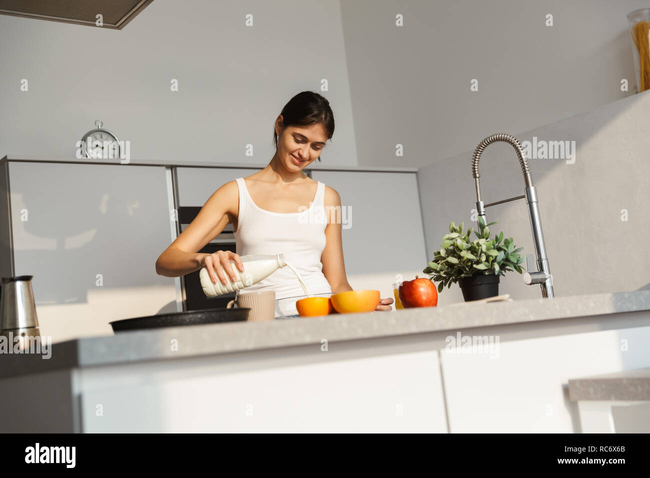 Image of an amazing happy healthy woman in the kitchen standing daily ...