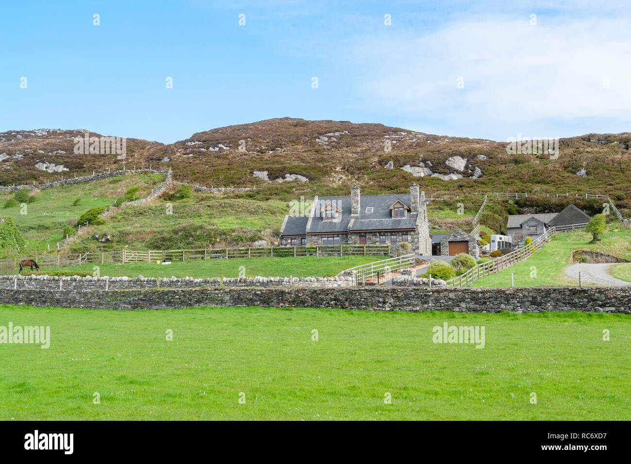 traditional house and surrounding stone walls seen in western Ireland ...