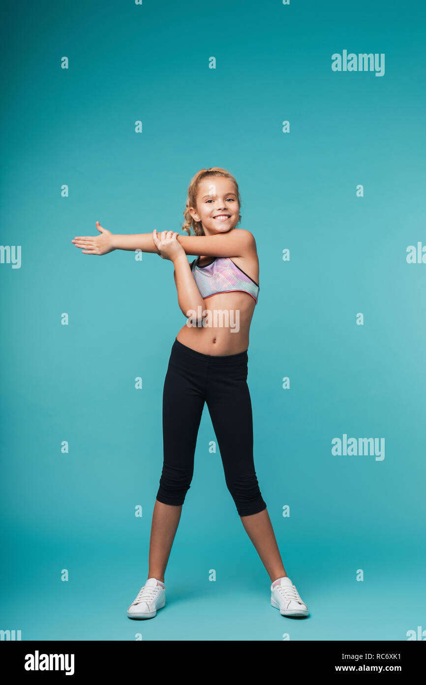 Image of a cute little girl child make fitness exercises isolated over ...