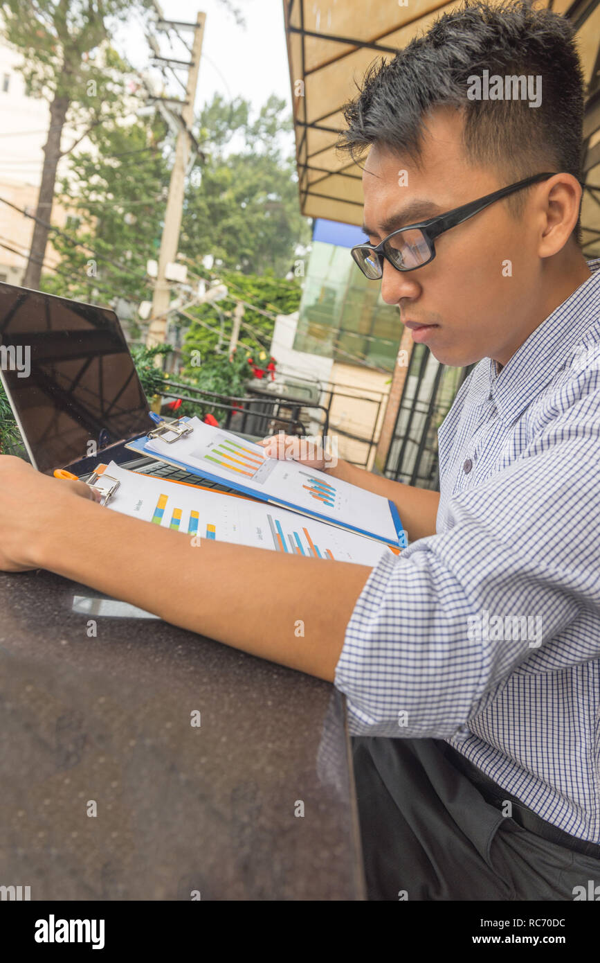 Office employee reading and analyzing data in document Stock Photo - Alamy