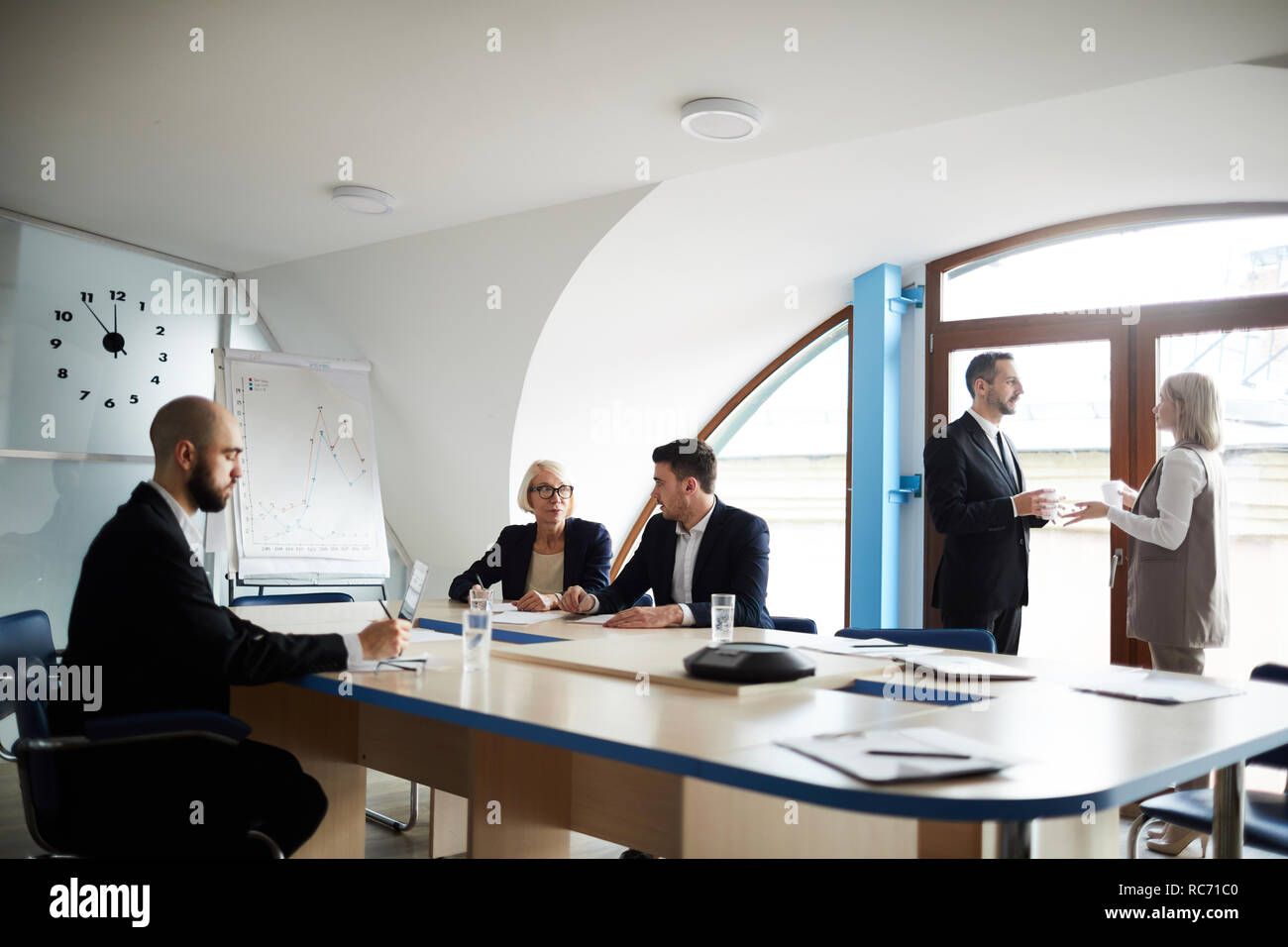 Working in boardroom Stock Photo - Alamy