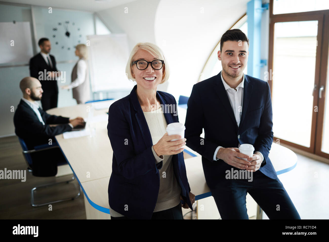 Colleagues having coffee break Stock Photo - Alamy