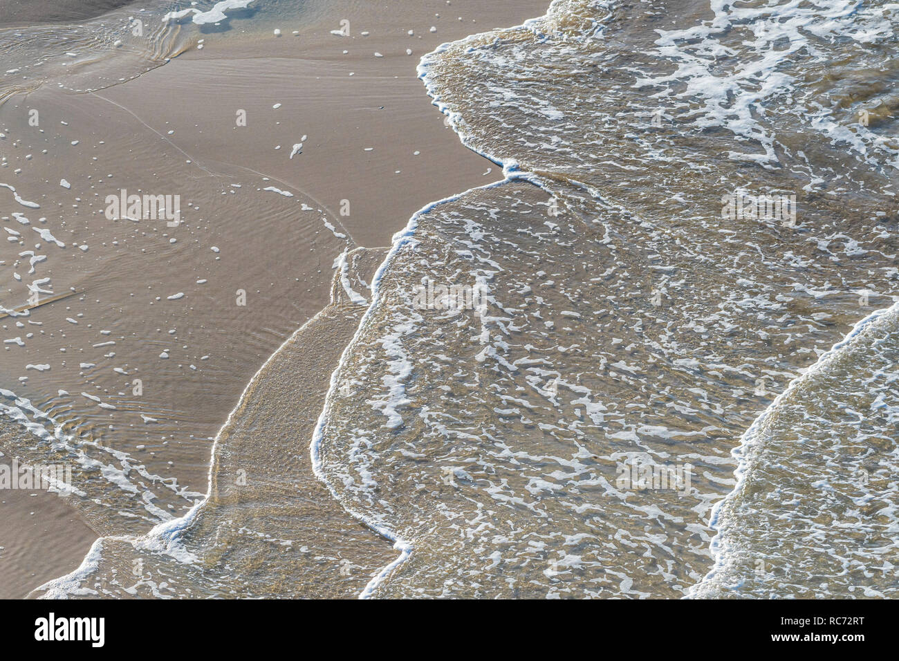 Incoming tide on a beach Stock Photo - Alamy