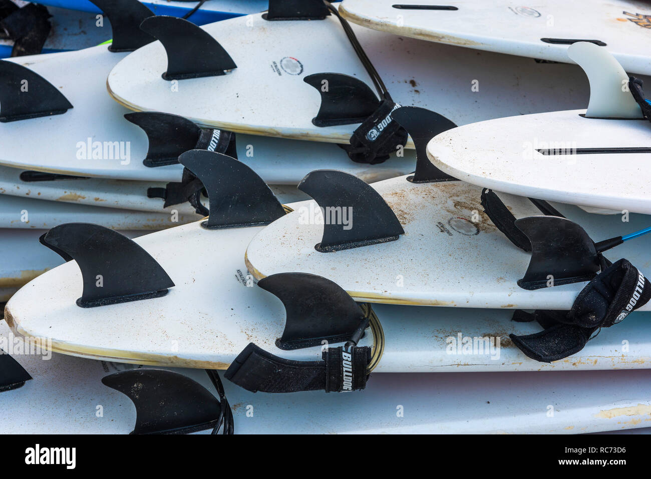A stack of surfboards showing the fins Stock Photo - Alamy
