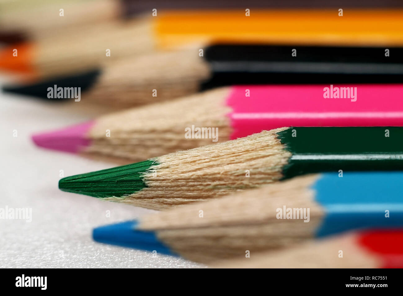 Colored pencils arranged in a row Stock Photo - Alamy
