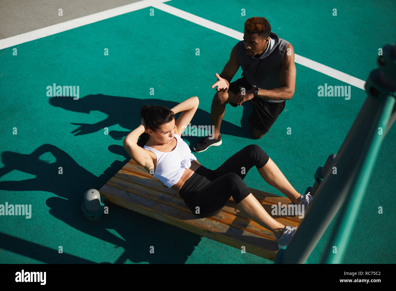 Fitness trainer giving advice to woman Stock Photo - Alamy