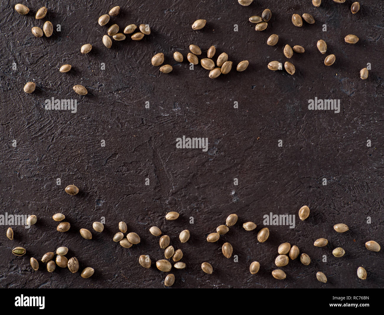 Hemp seeds top view. Unpeeled raw organic hemp seed on black background ...