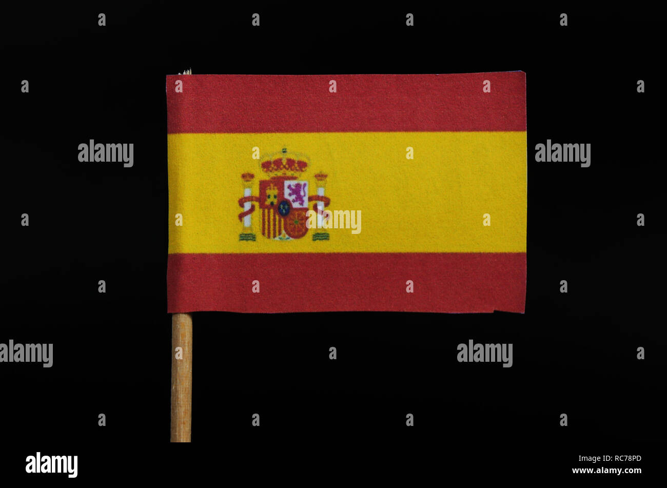 A official and national flag of Spain on toothpick on black background ...