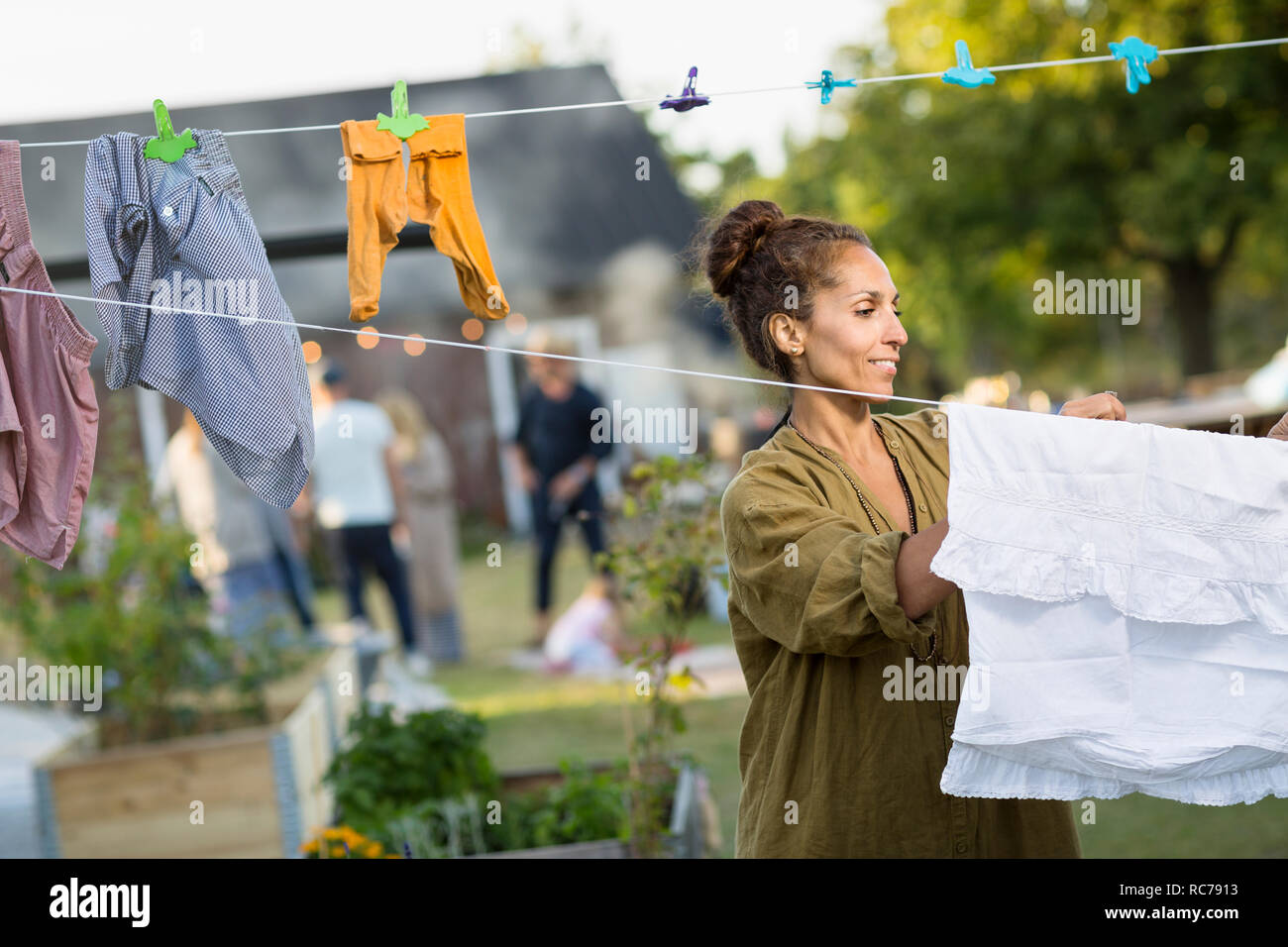 Woman hanging laundry Stock Photo - Alamy