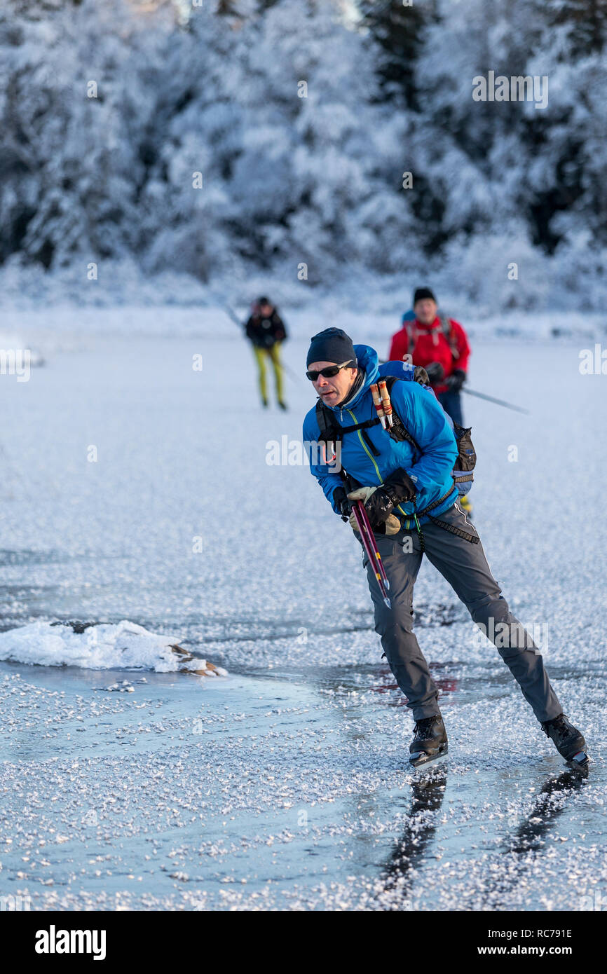 Three people moving on ice Stock Photo - Alamy