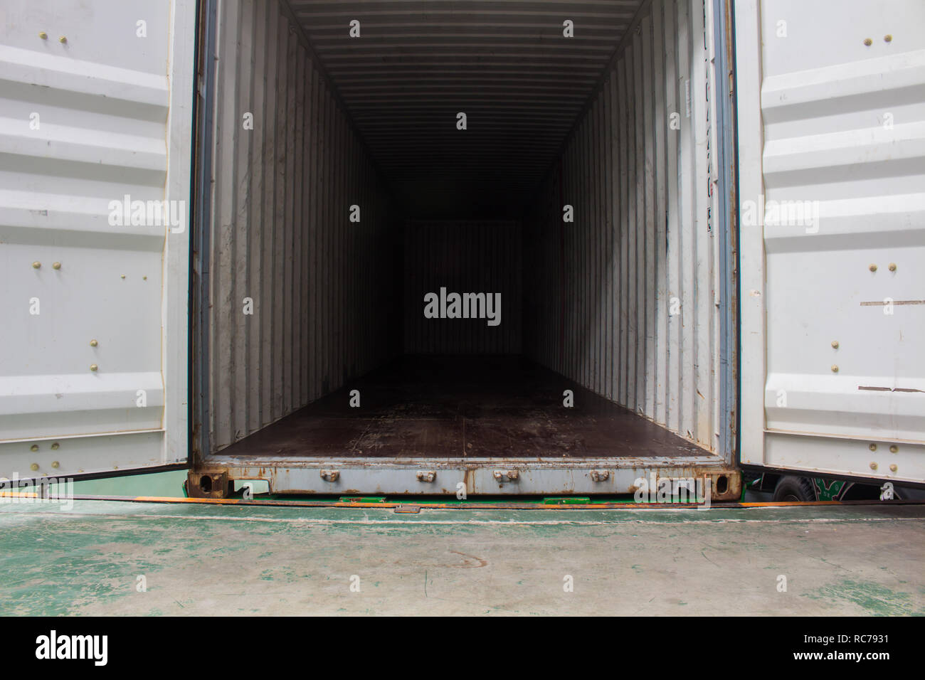 The empty container inside warehouse on shipment area Stock Photo - Alamy