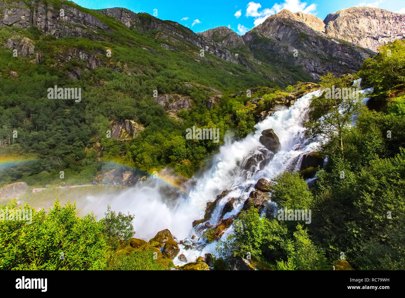 Waterfall and rainbow on the way to Briksdal or Briksdalsbreen glacier ...