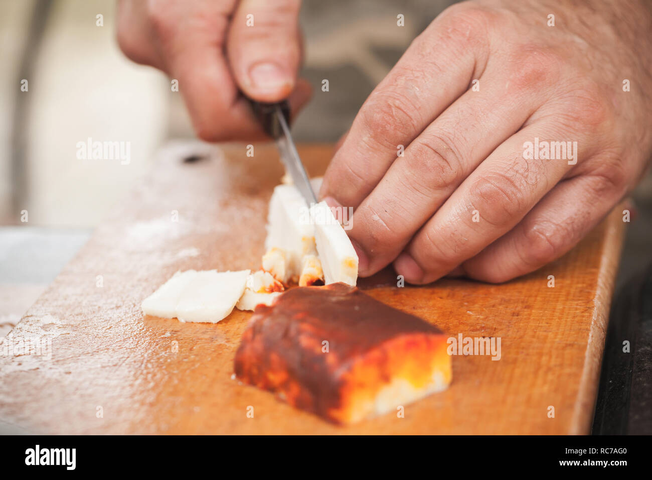 Smoked lard slicing. Hands of cook with knife, close-up photo with ...