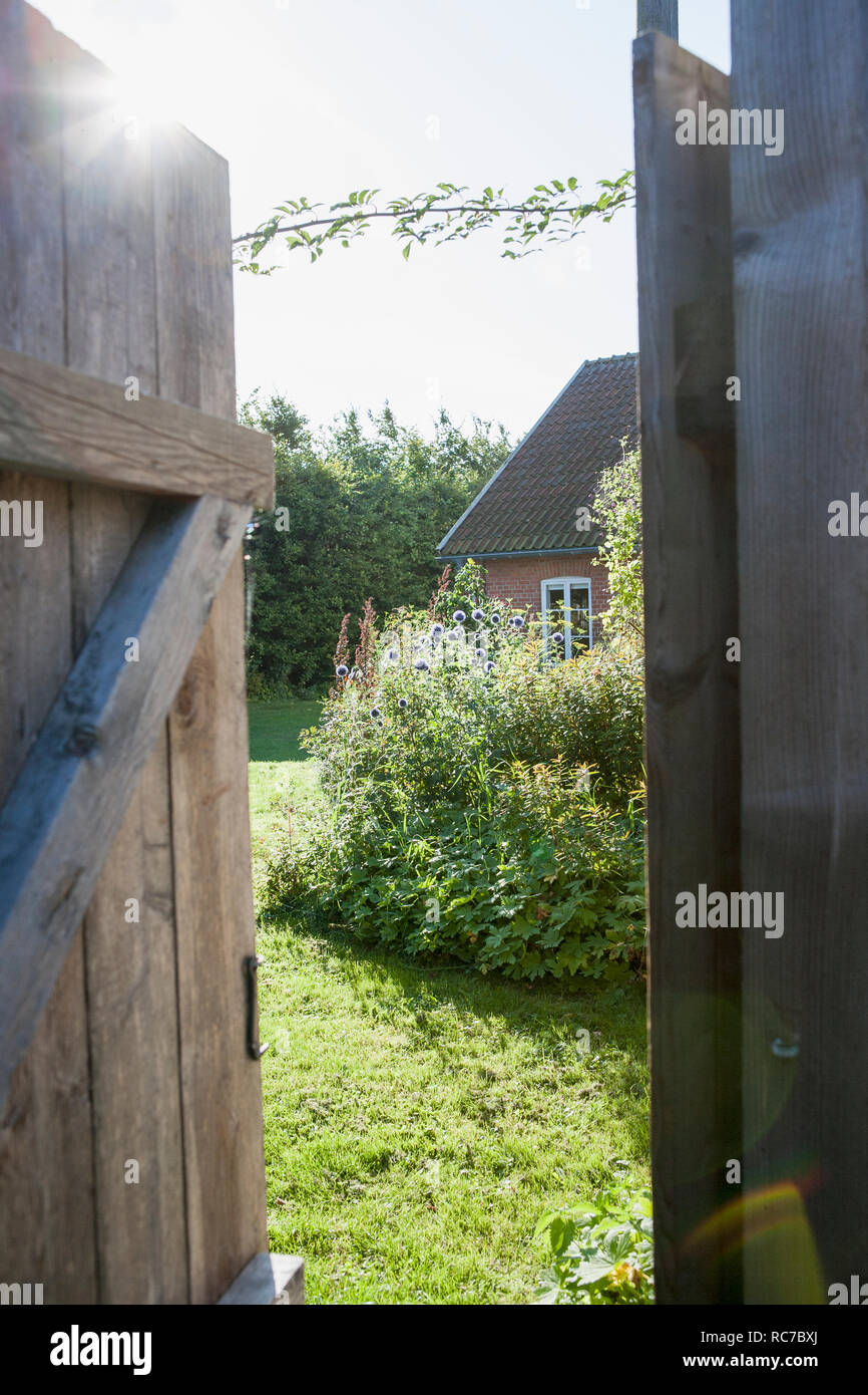 Open door with house in background Stock Photo - Alamy