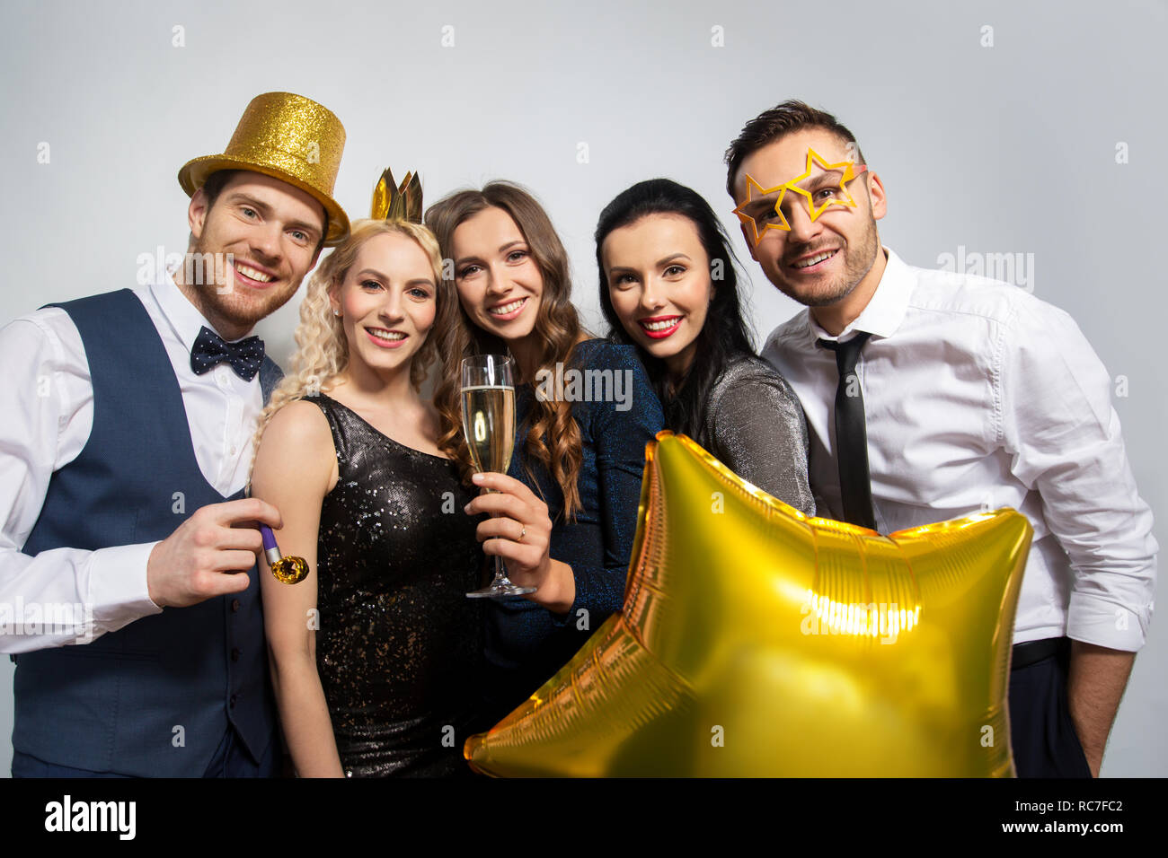 happy friends with golden party props posing Stock Photo - Alamy