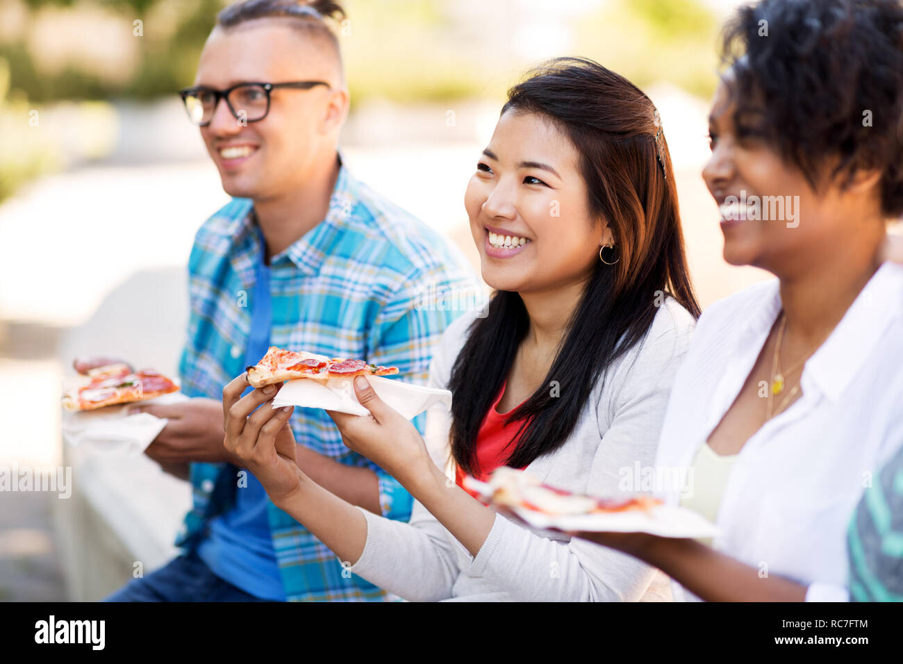happy friends eating sandwiches and pizza outdoors Stock Photo - Alamy