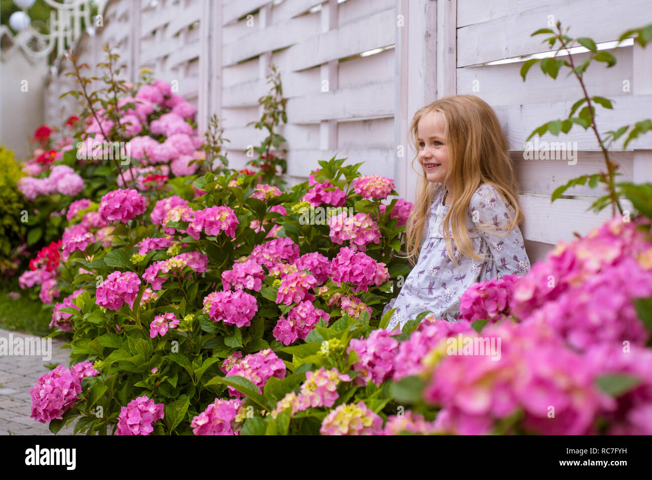 Spring flowers. Childhood. Little girl at blooming flower. Summer ...