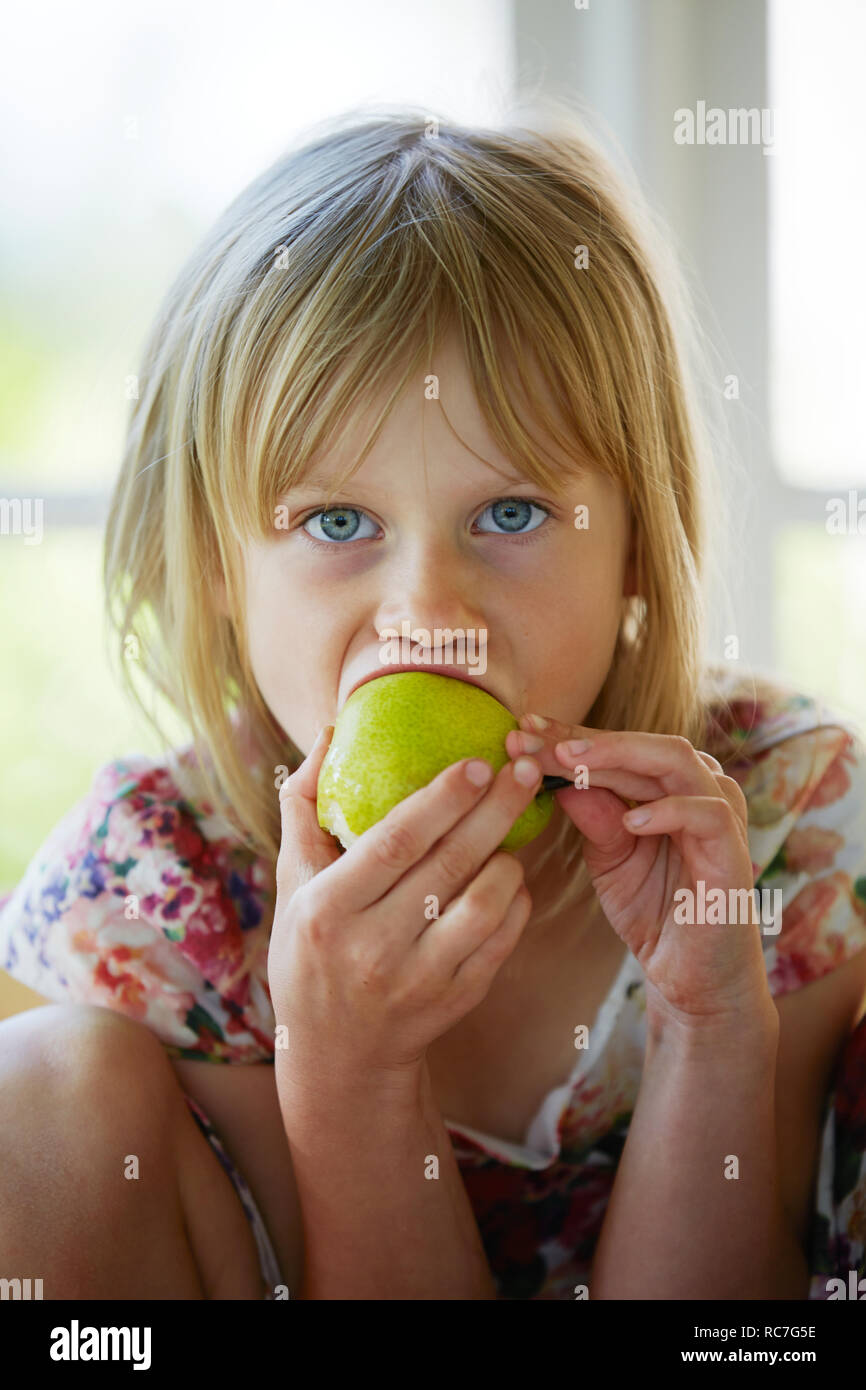 Blonde girl eating apple hi-res stock photography and images - Alamy
