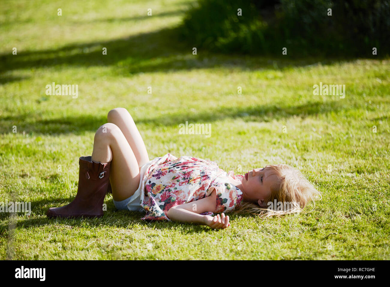 Girl Lying In Grass Stock Photo Alamy