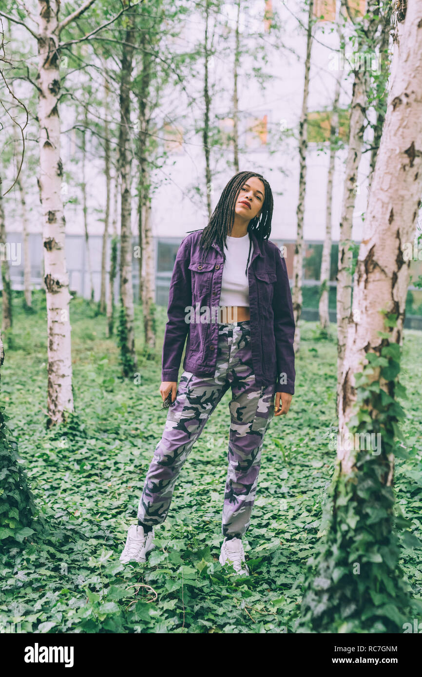 Woman standing among trees on hi-res stock photography and images - Alamy