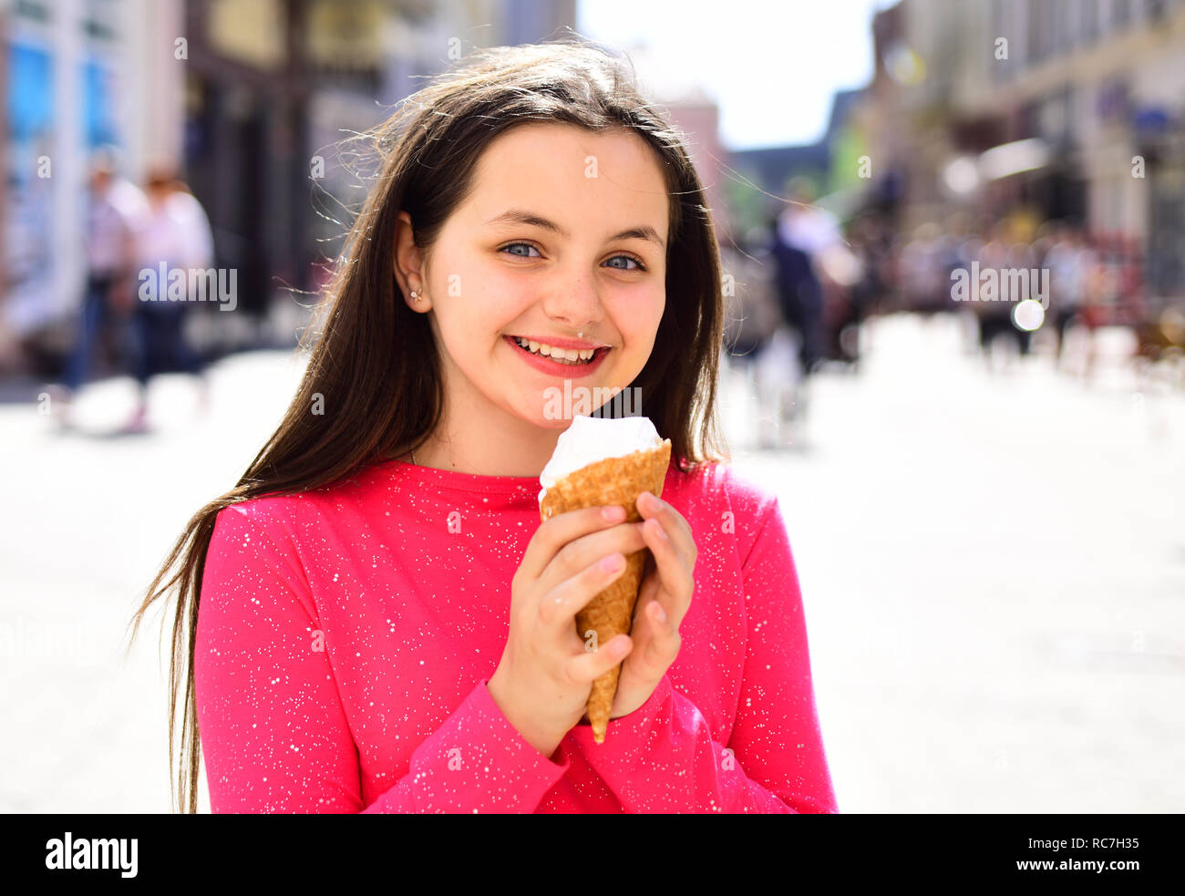 Pure and sweet cream. Pretty girl hold ice cream cone on summer day ...