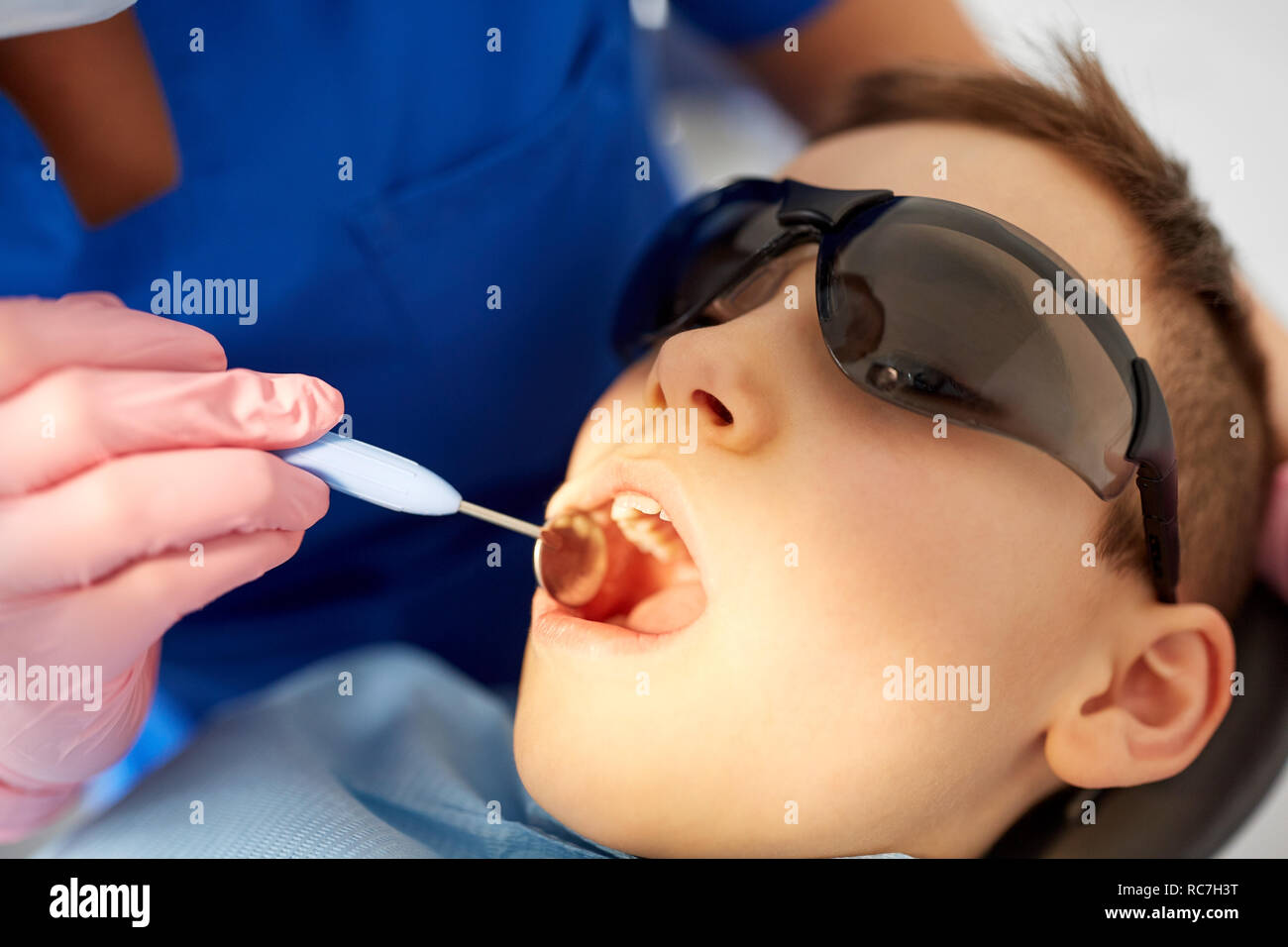 boy having teeth checkup at dental clinic Stock Photo - Alamy