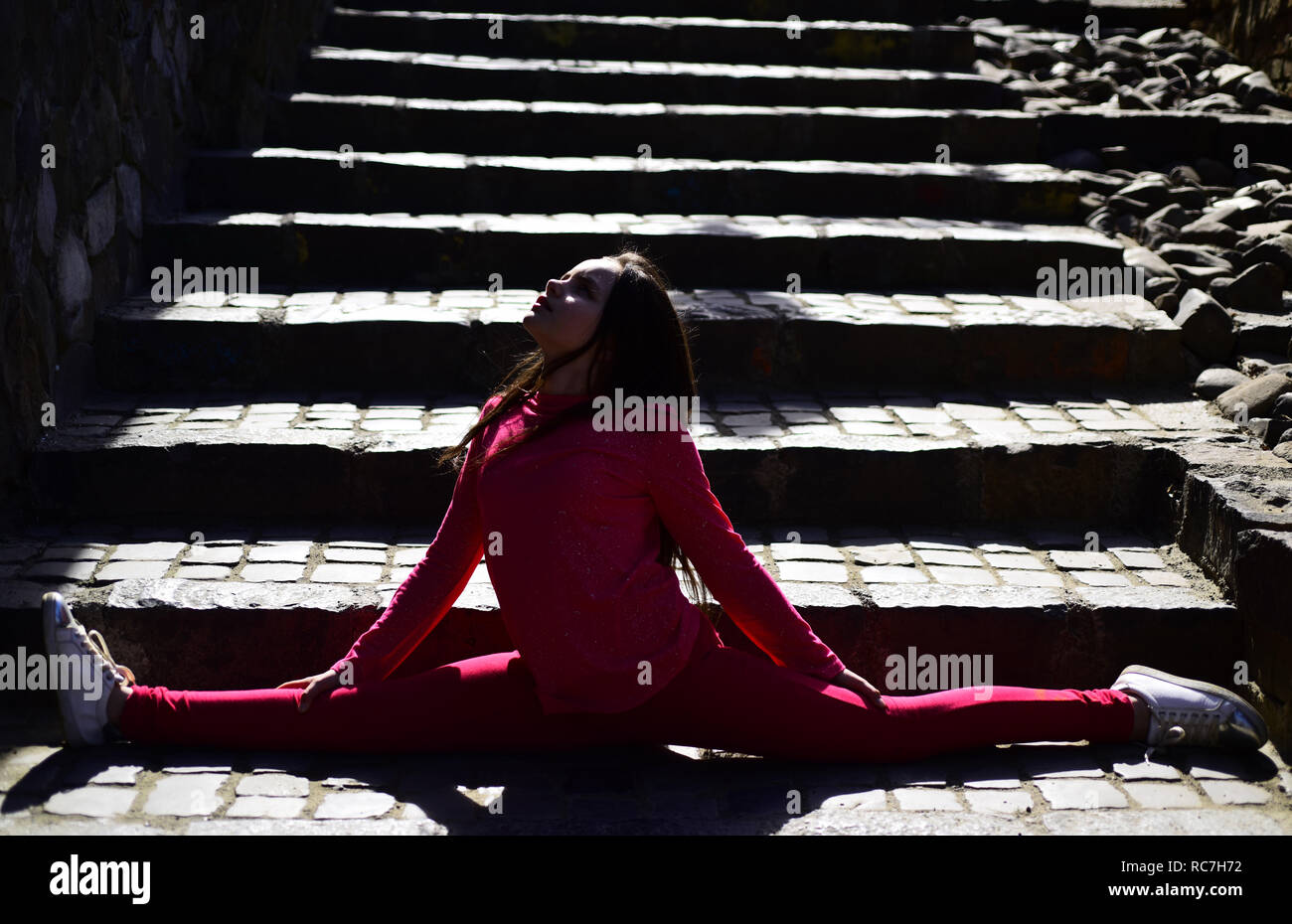 Fitness and flexebility. Small child girl stretching legs muscle ...