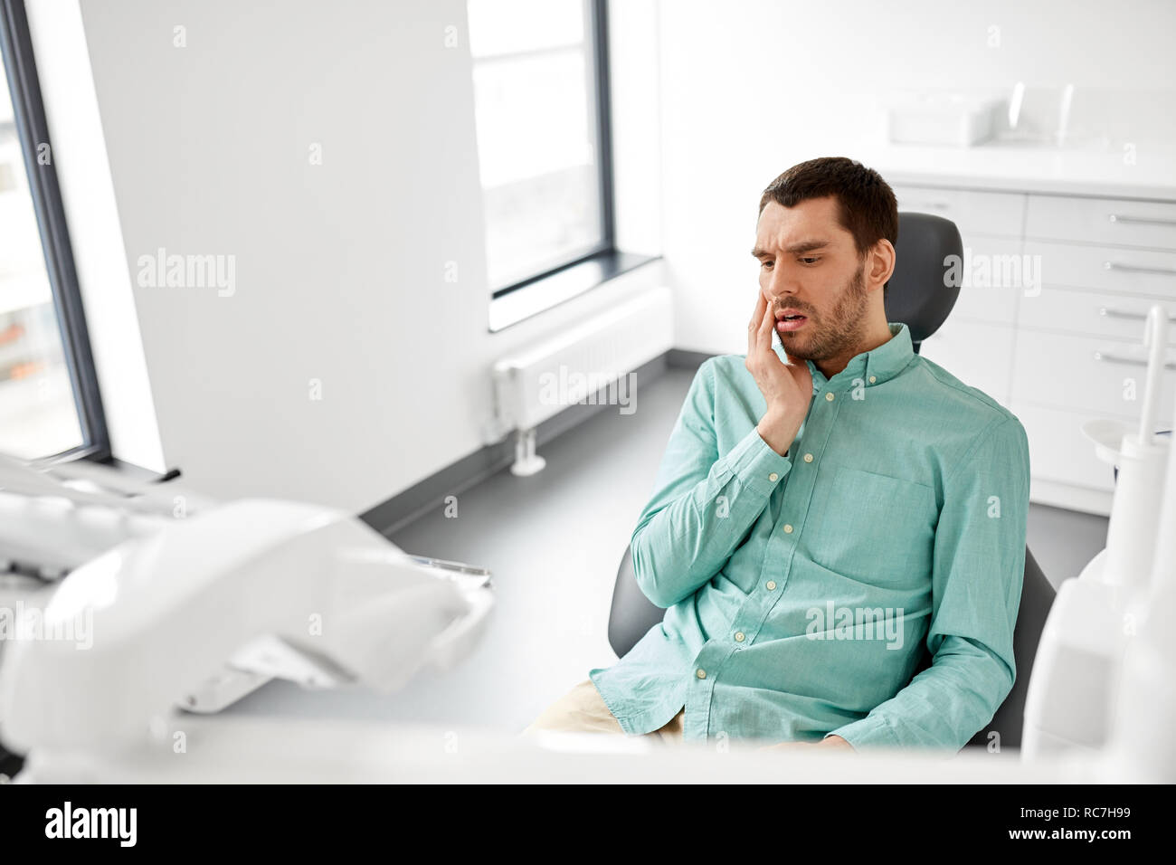 patient suffering from toothache at dental clinic Stock Photo - Alamy