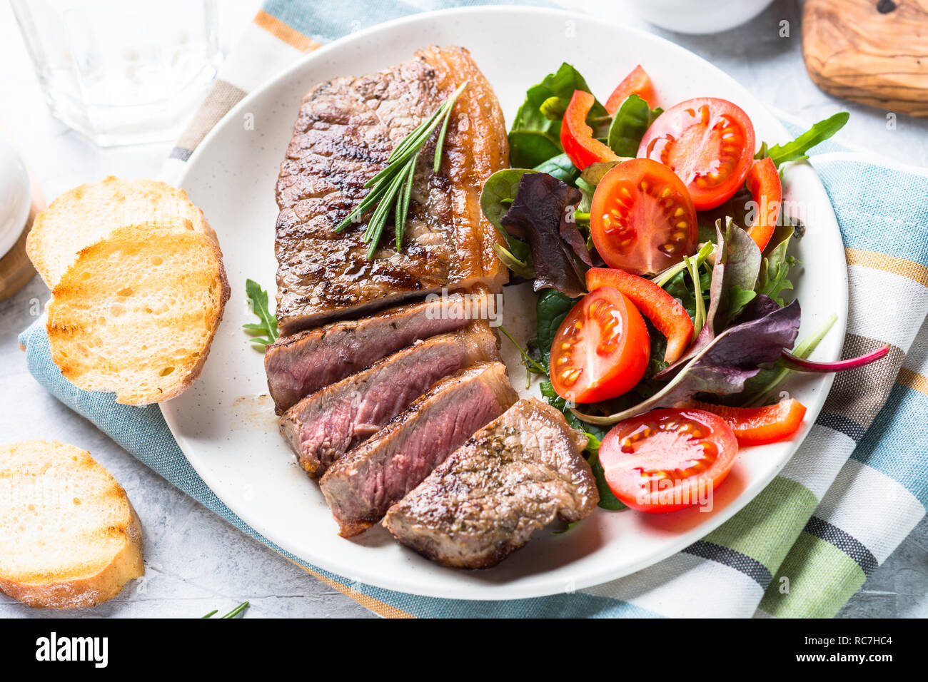 Grilled beef striploin steak with fresh salad Stock Photo - Alamy