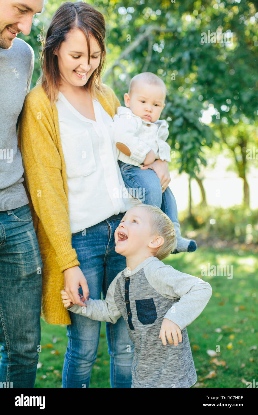 Family with two children in park Stock Photo - Alamy