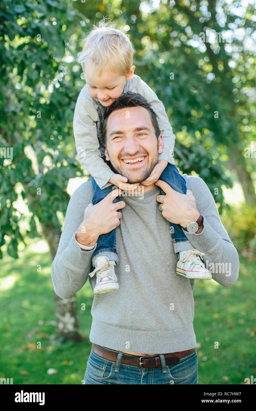 Father carrying son piggyback Stock Photo - Alamy