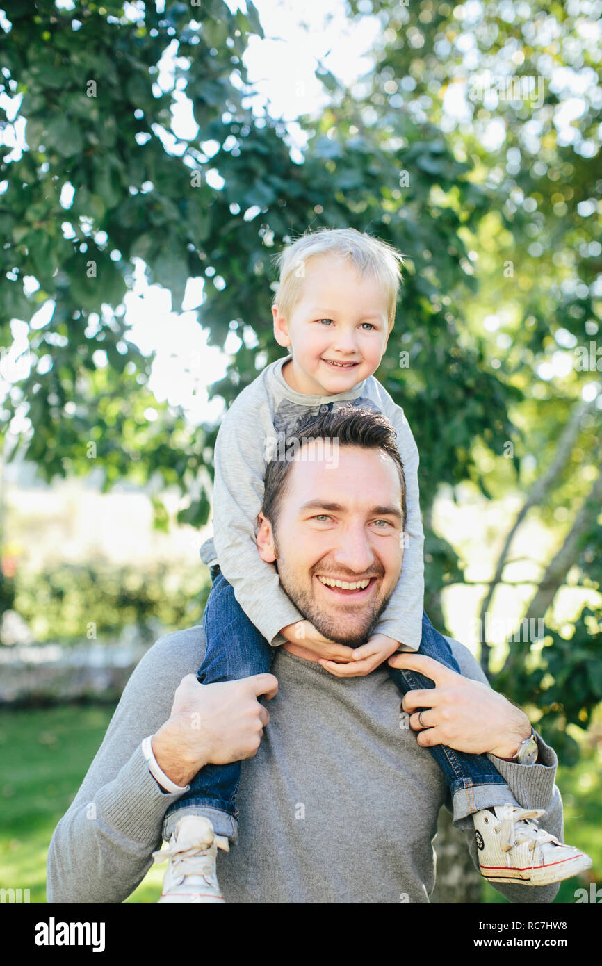 Father carrying son piggyback Stock Photo - Alamy