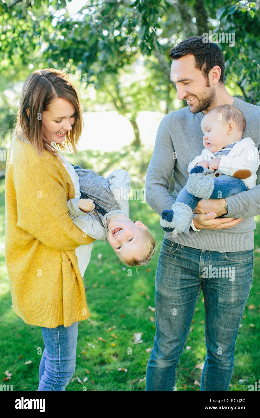 Family with two children in park Stock Photo - Alamy