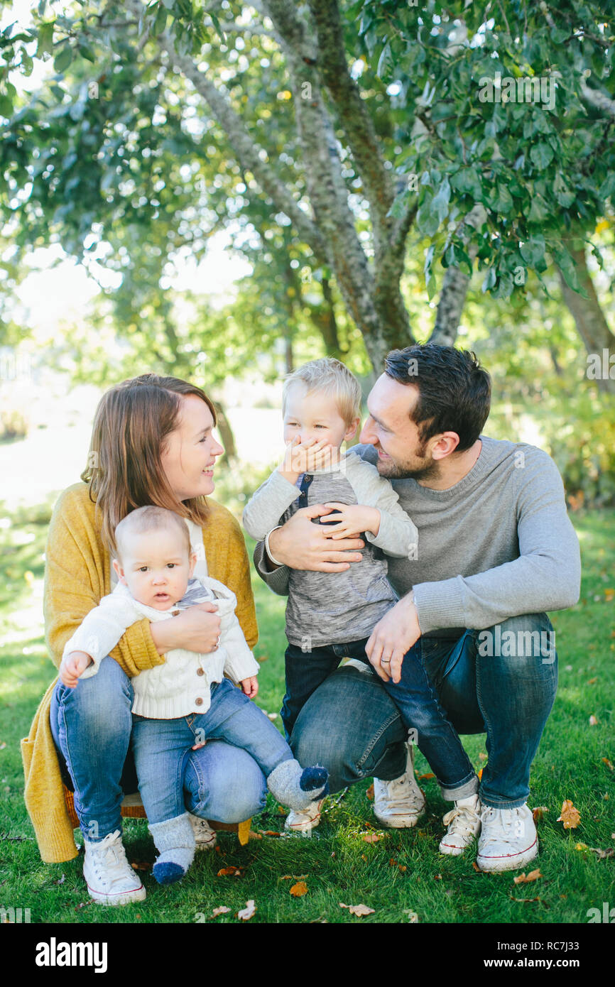 Family with two children in park Stock Photo - Alamy