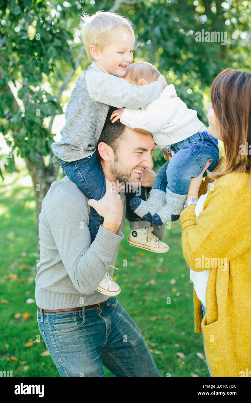 Family with two children in park Stock Photo - Alamy