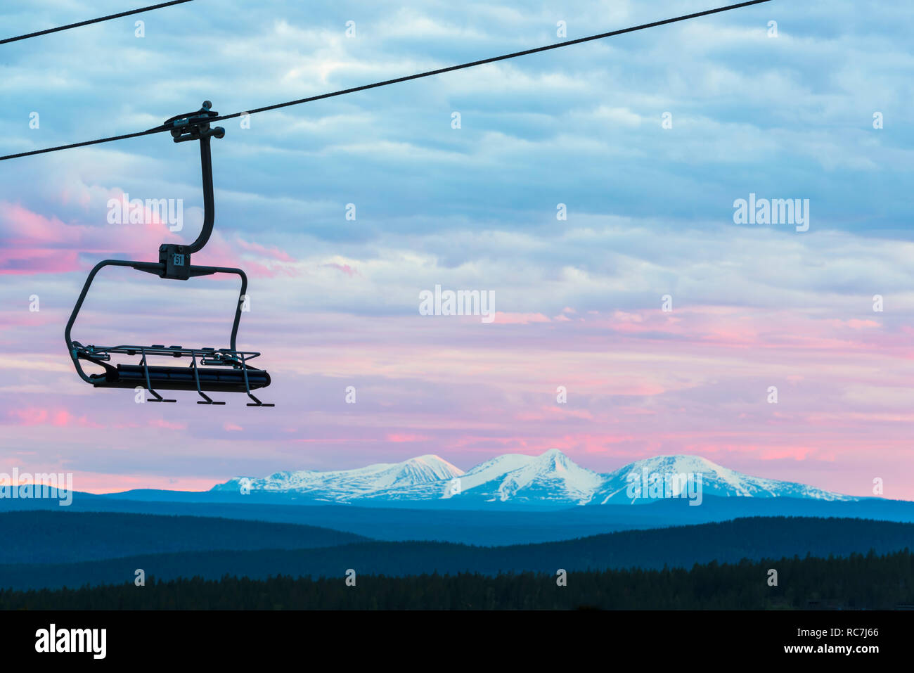 Chairlift with mountain landscape in background Stock Photo - Alamy