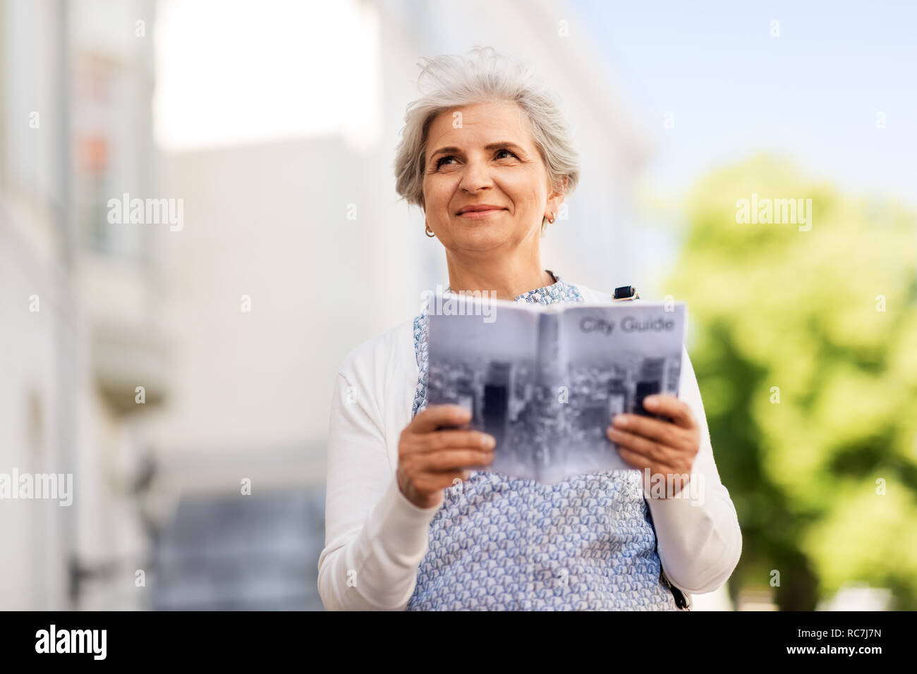 senior woman or tourist with city guide outdoors Stock Photo - Alamy