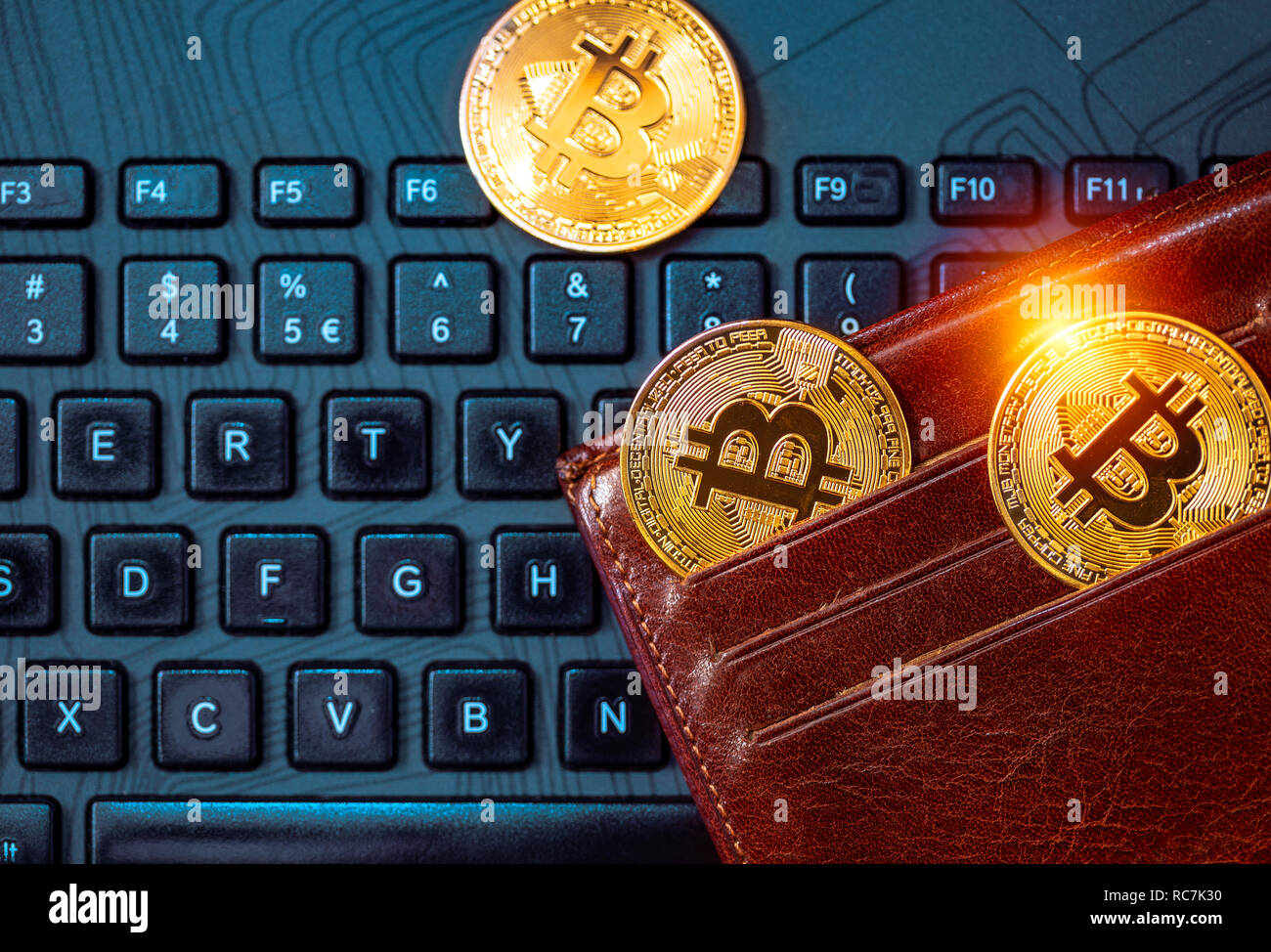 Bitcoin out of a wallet over keyboard. Crypto currency. New virtual ...