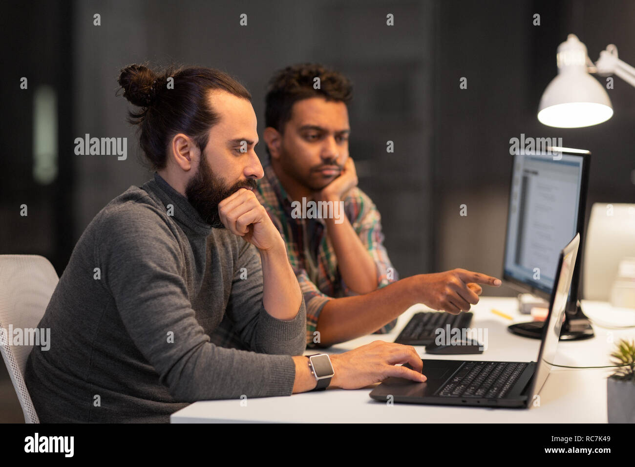 creative team with computer working late at office Stock Photo - Alamy