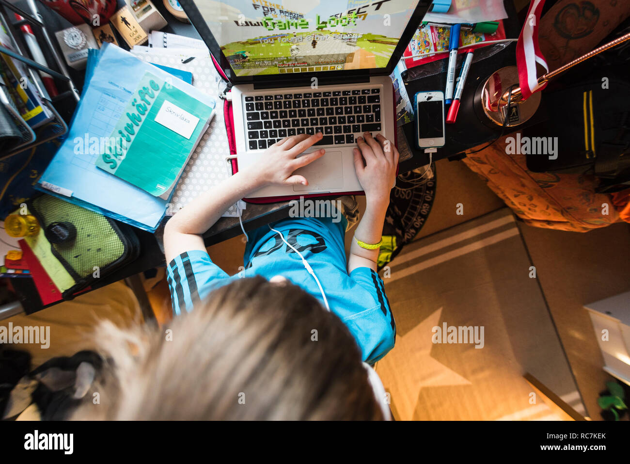 Boy playing games on laptop Stock Photo - Alamy