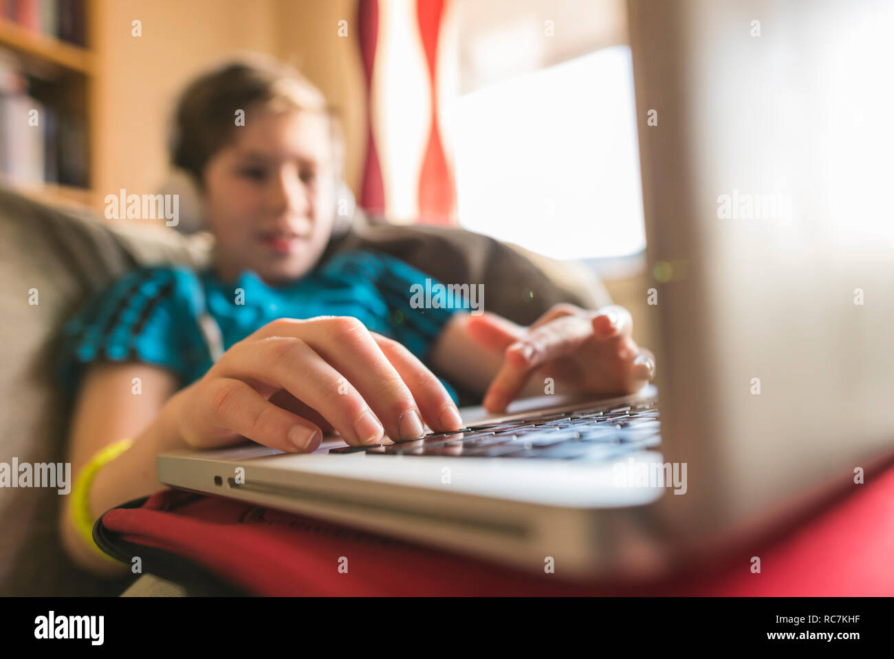 Boy using laptop at home Stock Photo - Alamy