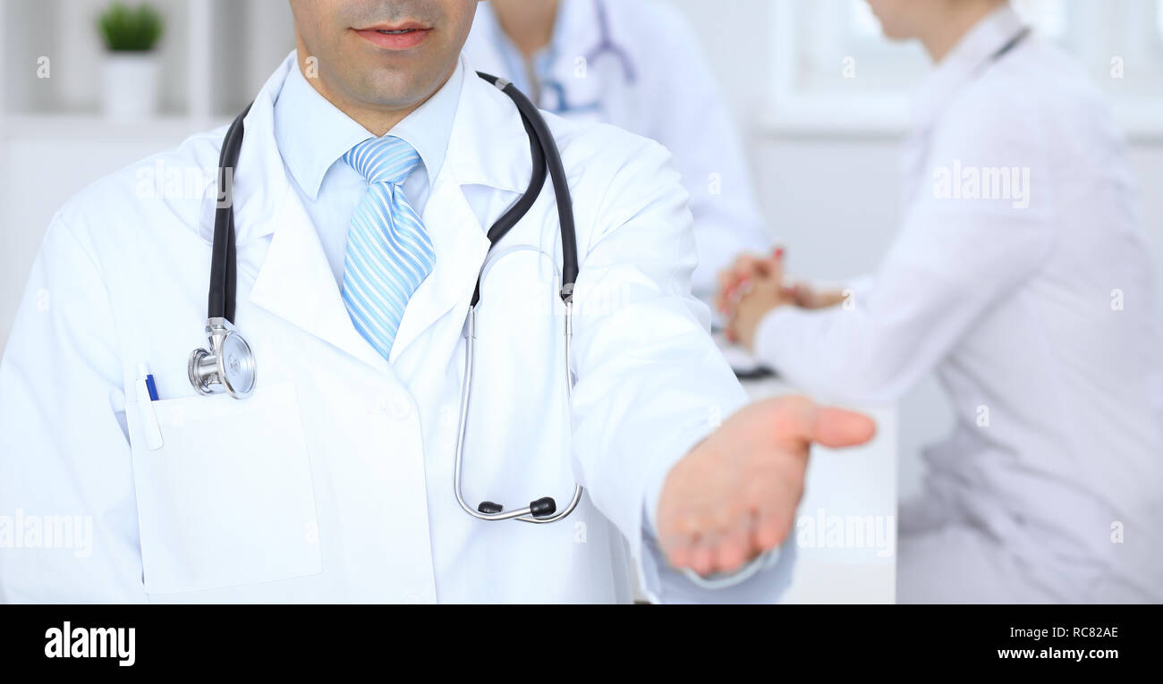 Happy doctor woman with medical staff at the hospital. Helping hand ...