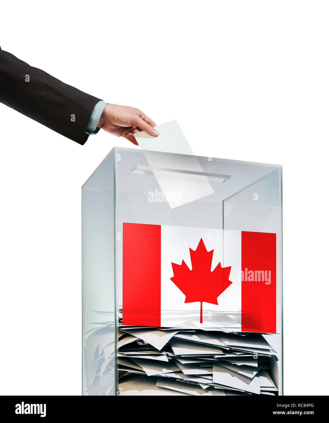 Hand inserting paper ballot in clear ballot box with canadian flag ...