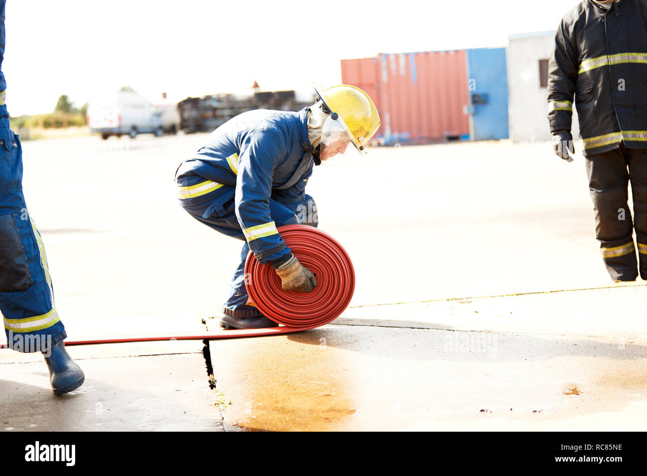 Firemen using hose hi-res stock photography and images - Alamy