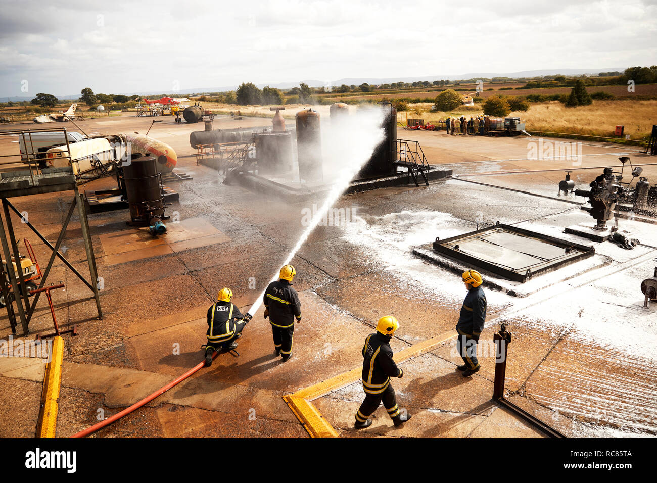 Firemen training, firemen spraying firefighting foam at oil storage ...