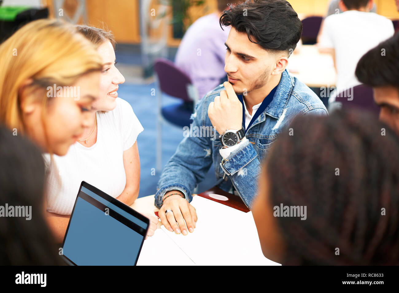 Female and male higher education students studying in college classroom ...