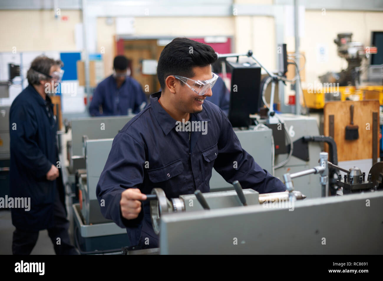 Student operating machine in workshop Stock Photo - Alamy